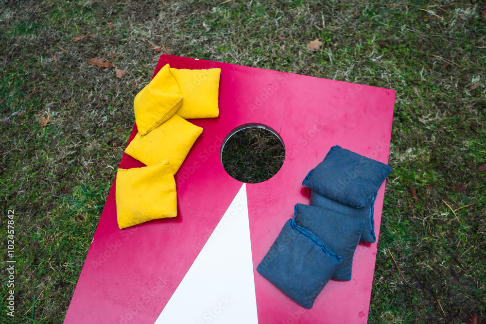 Cornhole Toss Board with Stacked Bean Bags Stock Photo | Adobe Stock