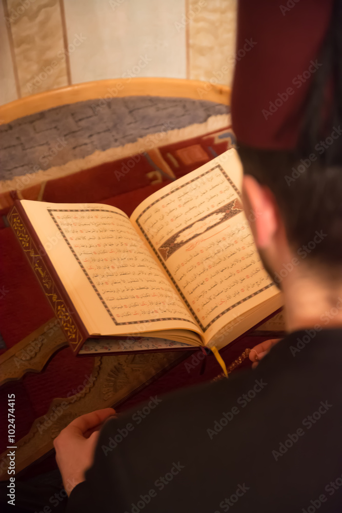 Muslim man reading the koran surah yasin Stock Photo | Adobe Stock