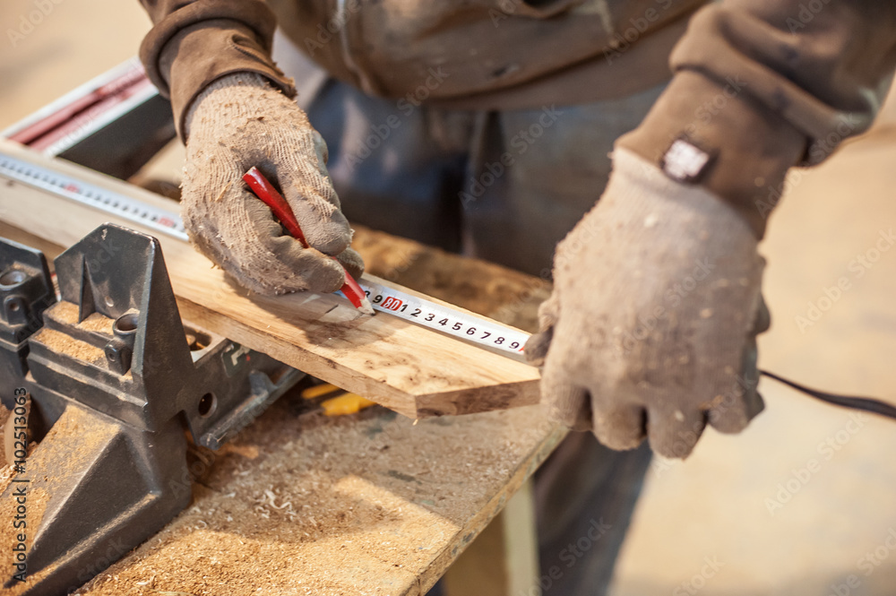 Construction Worker Using Tape Measure / Professional carpenter at work ...