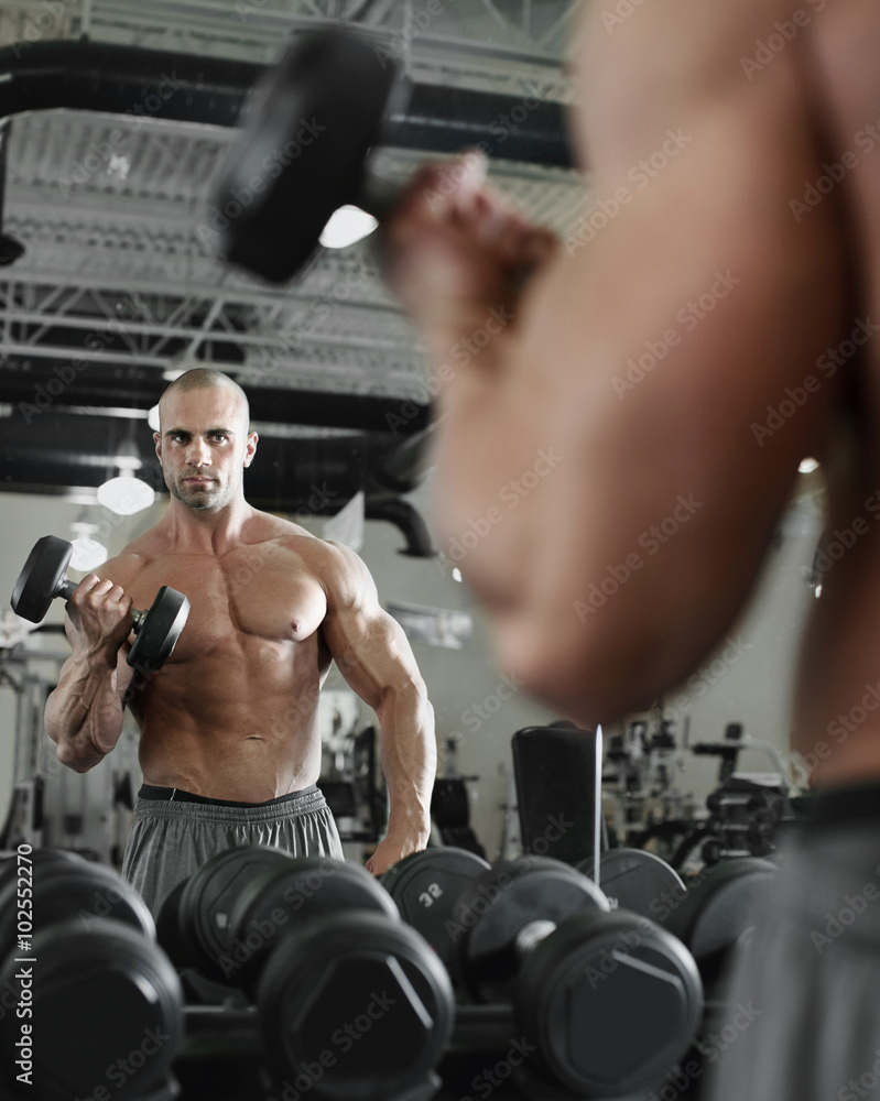 bodybuilder working out with bumbbells weights at the gym Stock Photo ...