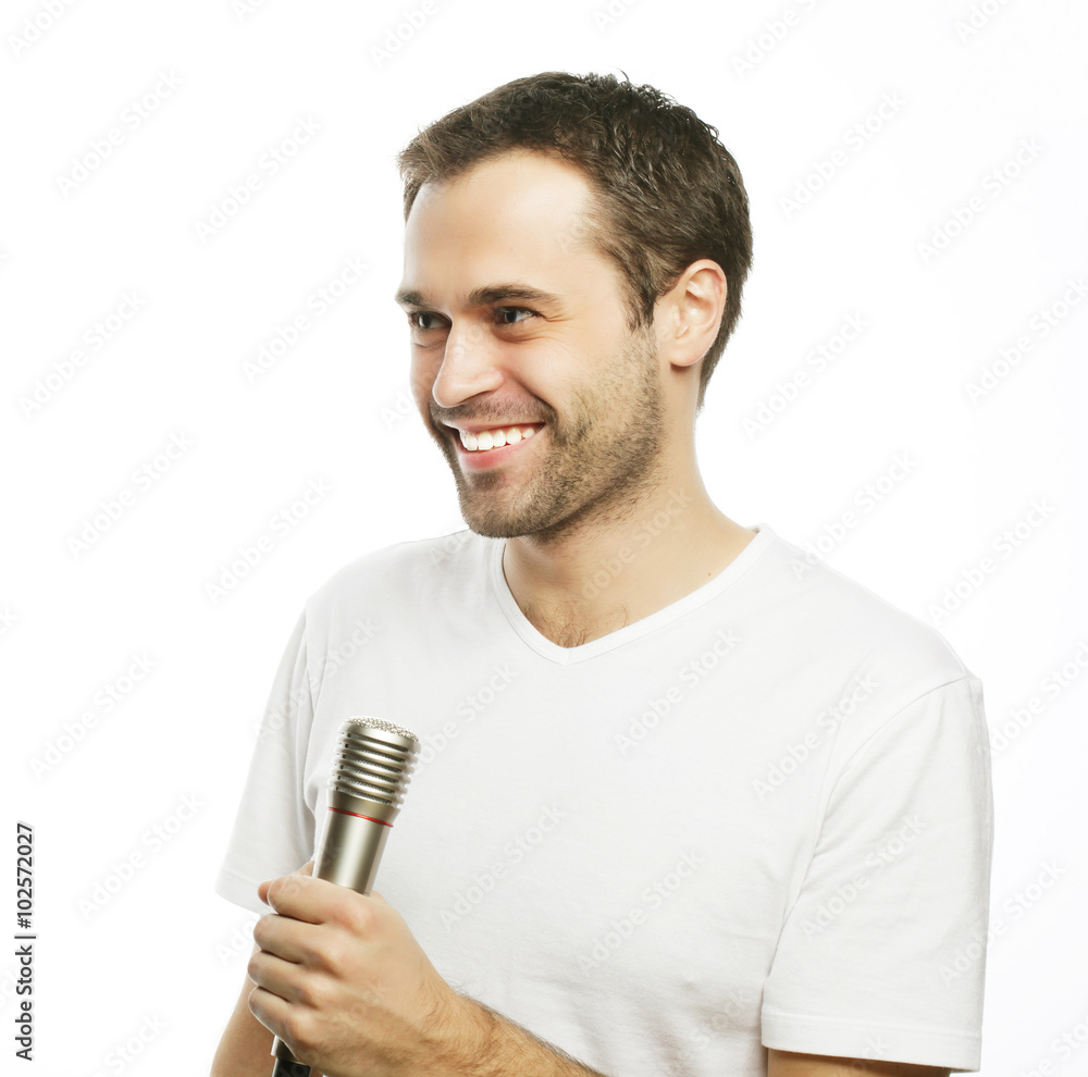 young man holding a microphone Stock Photo | Adobe Stock