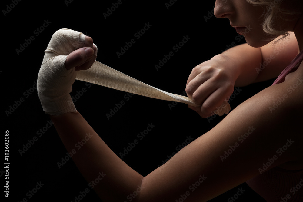 Ready for fight / Beautiful and fit female fighter getting prepared for ...