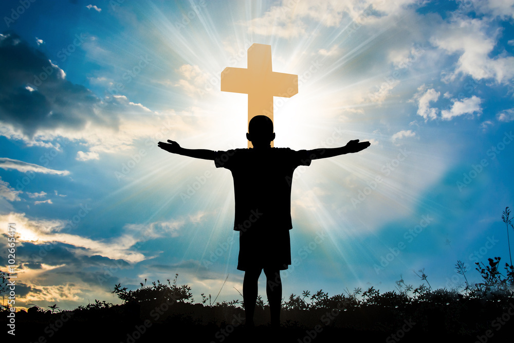 Silhouette of boy praying to a cross with heavenly cloudscape su Stock ...