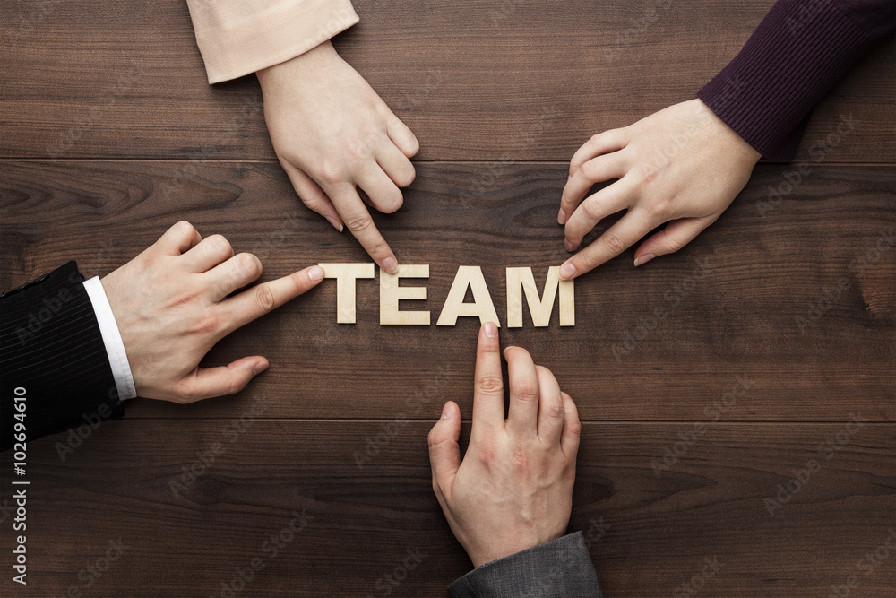 Team concept. Different hands of men and women connect letters into one ...