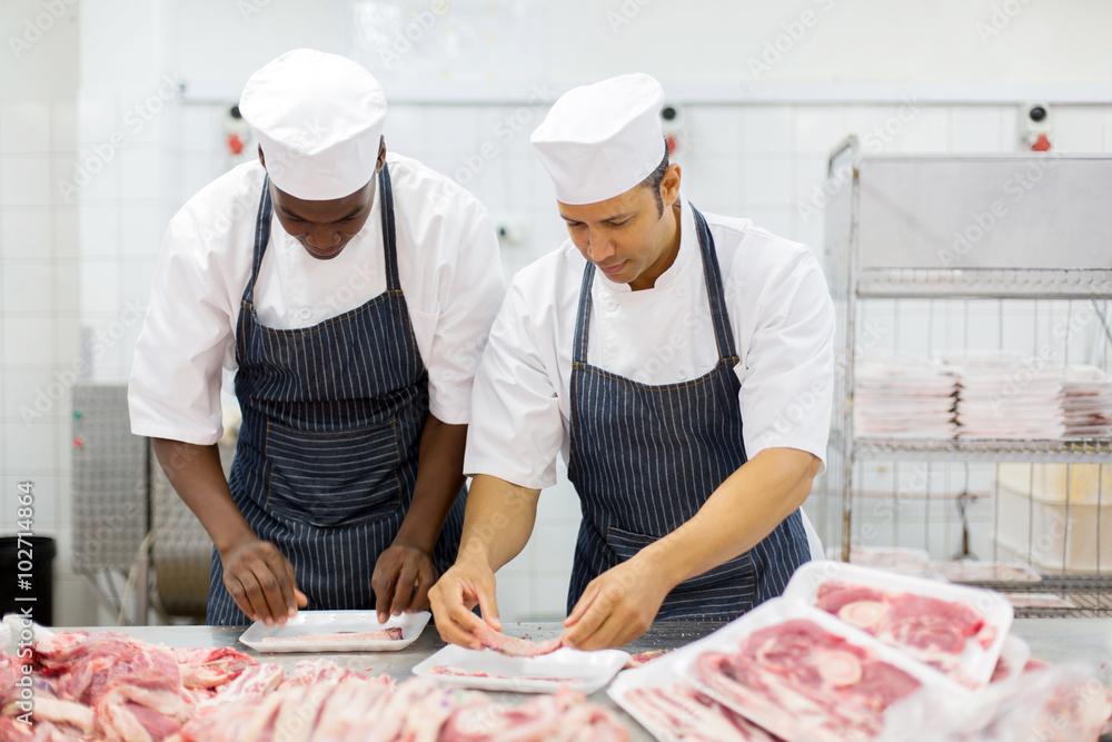 butchers packing meat pieces Stock Photo | Adobe Stock