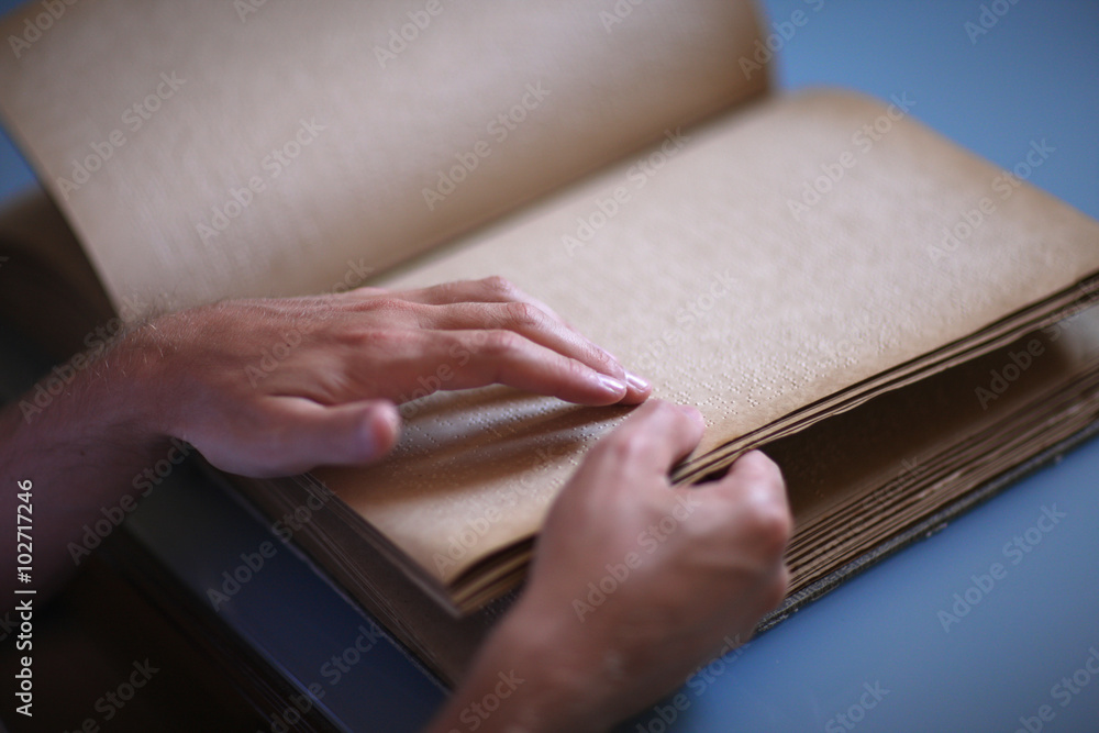 Tactile book for blind readers, hands in focus foto de Stock | Adobe Stock