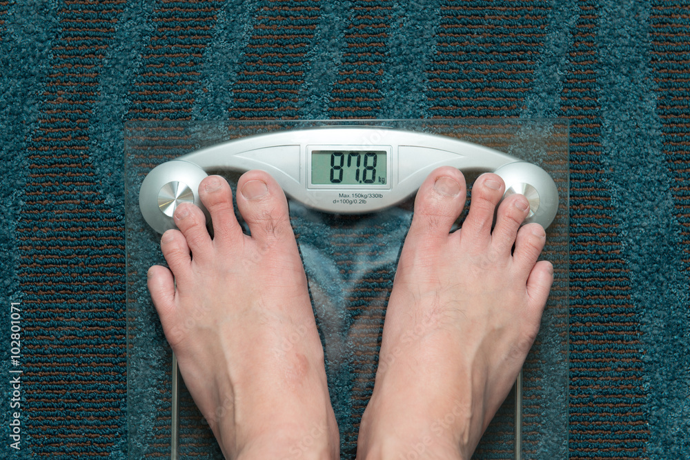 Feet on weight scale Stock Photo | Adobe Stock