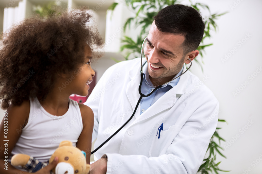 Positive pediatrician doctor examining kid Stock Photo | Adobe Stock