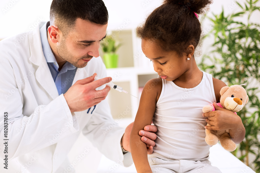 Brave little girl receiving injection Stock Photo | Adobe Stock