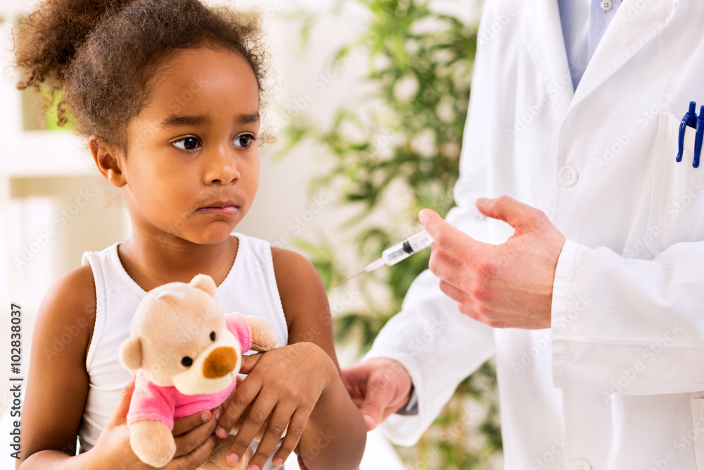Brave little girl receiving injection Stock Photo | Adobe Stock