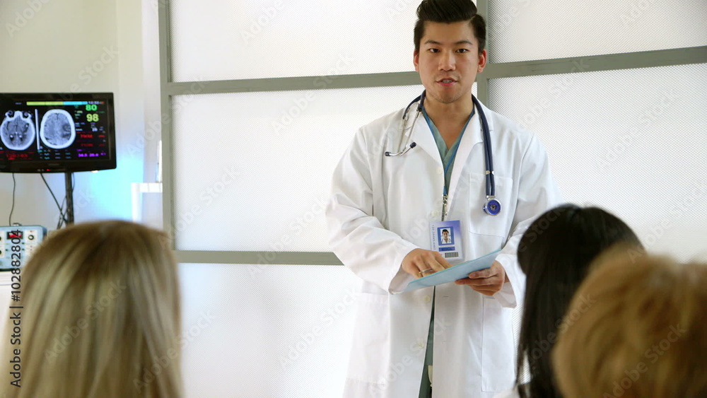 A young enthusiastic medical team leader preparing the staff for some ...
