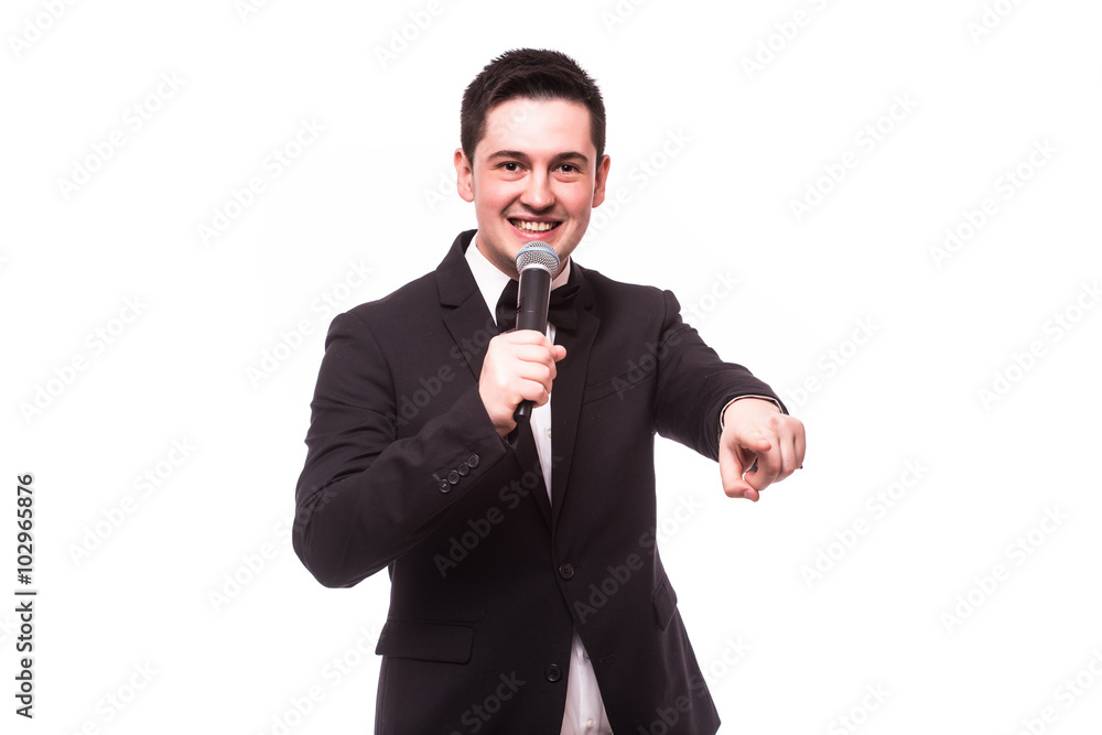 Young elegant talking man holding microphone talking with pointing ...