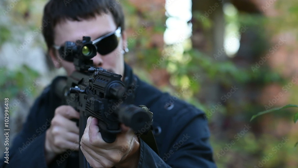 the man in the black jacket aims a gun at the camera, which then slowly ...