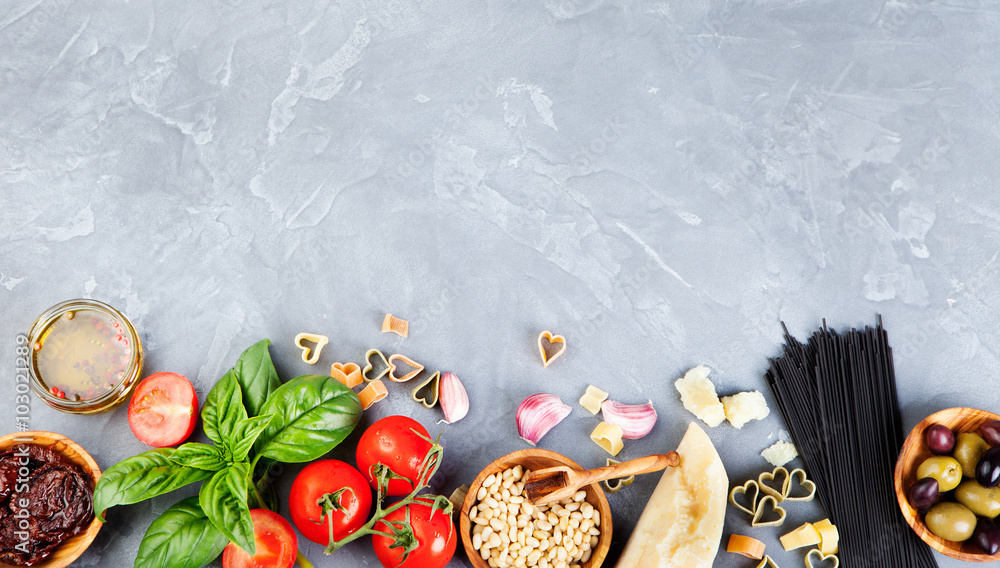 Italian food background with vine tomatoes, basil, spaghetti, parmesan ...