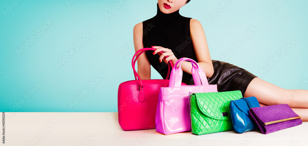 Woman touching many colorful purses. handbags. Copy space on the ...
