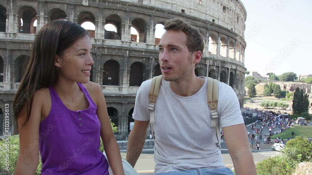 Couple in Rome by Colosseum talking in Italy. Happy young friends ...