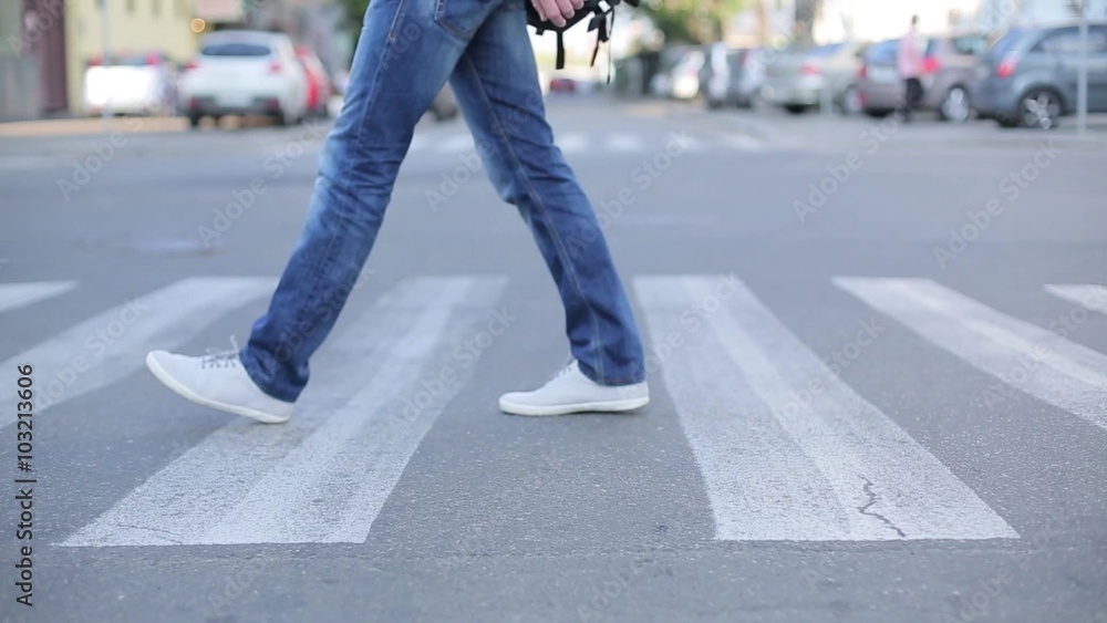 Man crossing the road at a zebra. Stock Video | Adobe Stock