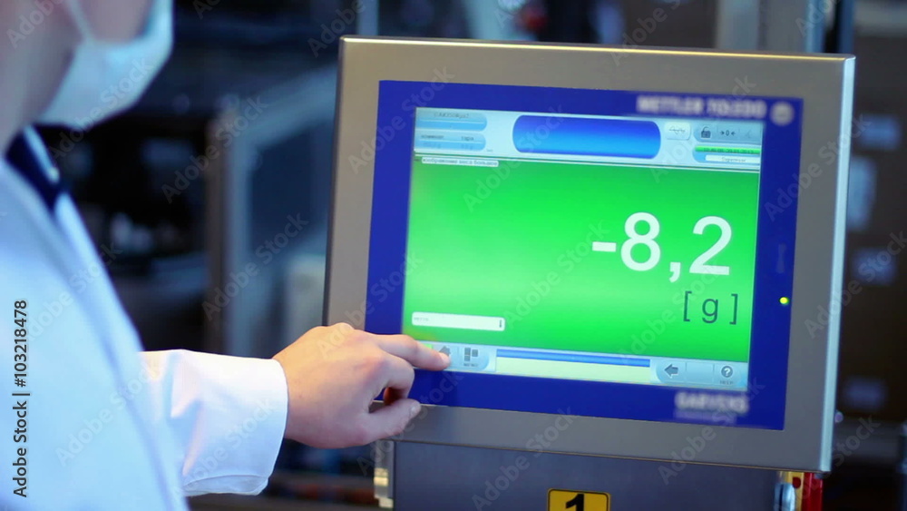 Factory worker check weigh/Industrial control panel display at food ...