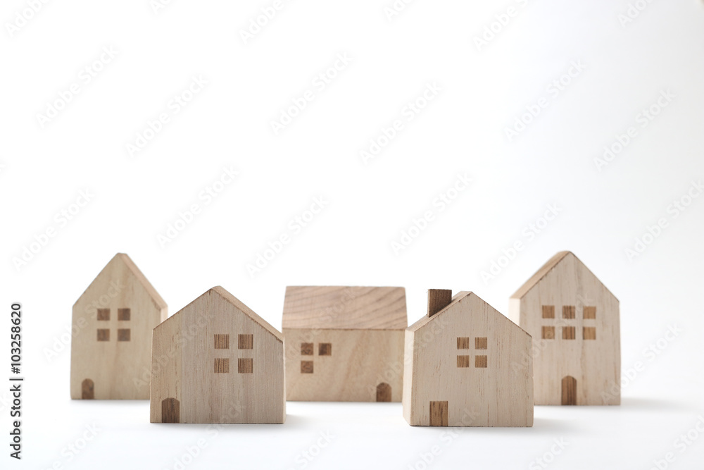 Miniature houses on white background. Building blocks arranged in row ...