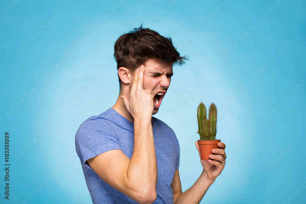 concept with a man holding a cactus Stock Photo | Adobe Stock