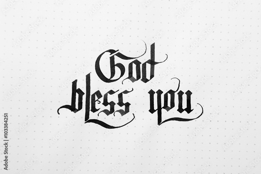 Calligraphical lettering God bless you on the paper note texture ...