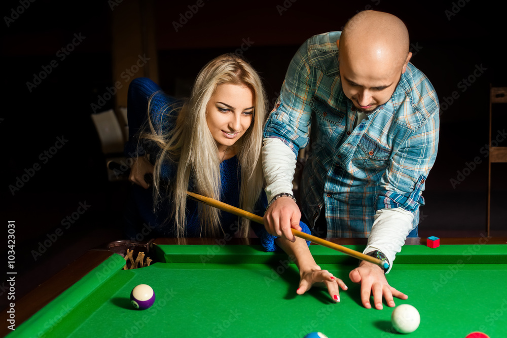 Teacher shows a girl how to play pool billiard Stock Photo | Adobe Stock
