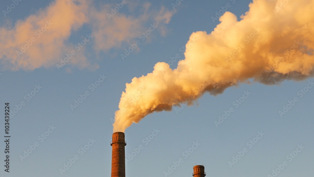 Factory plant smoke stack over blue sky background. Energy generation ...