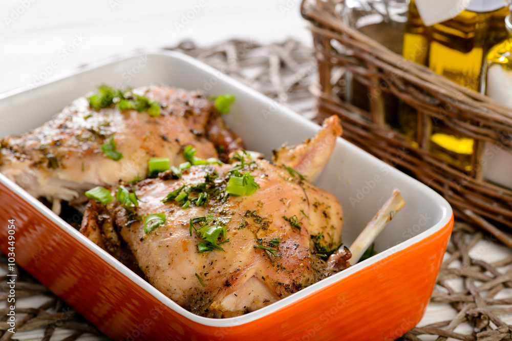 Oven baked rabbit with herbs on wooden table. foto de Stock | Adobe Stock