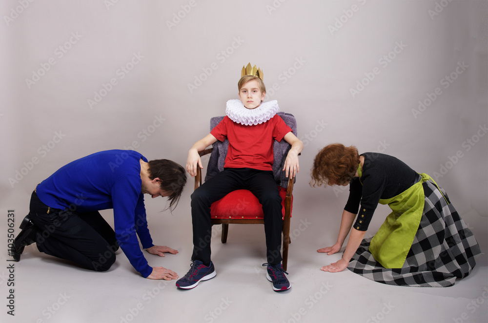 Parents kneel down before their son. Parenting style concept Stock Photo | Adobe Stock