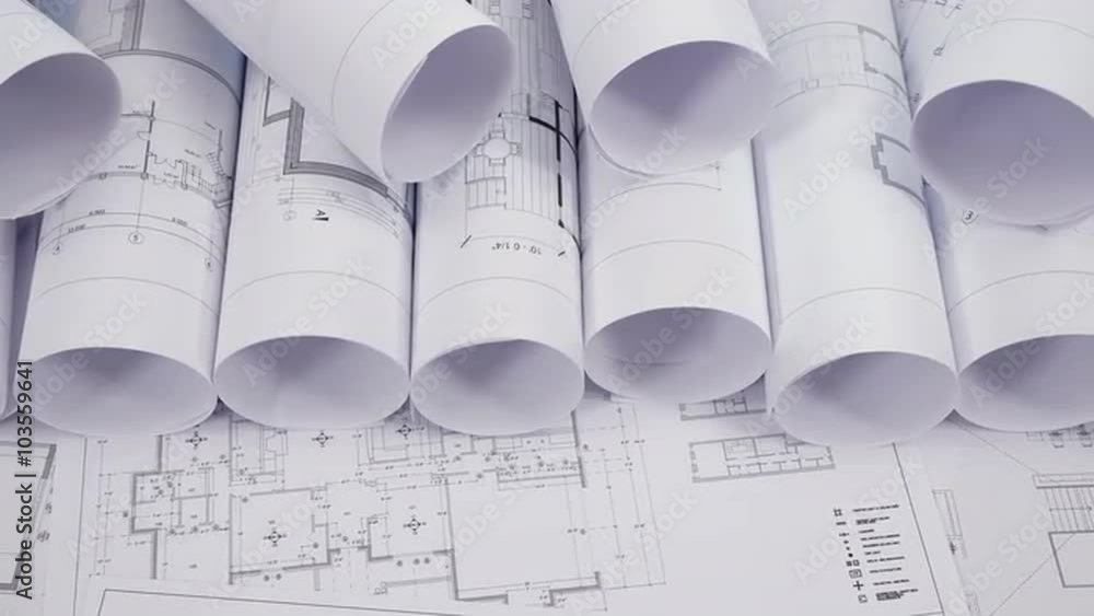Camera slides over architectural blueprints scattered randomly on desk ...
