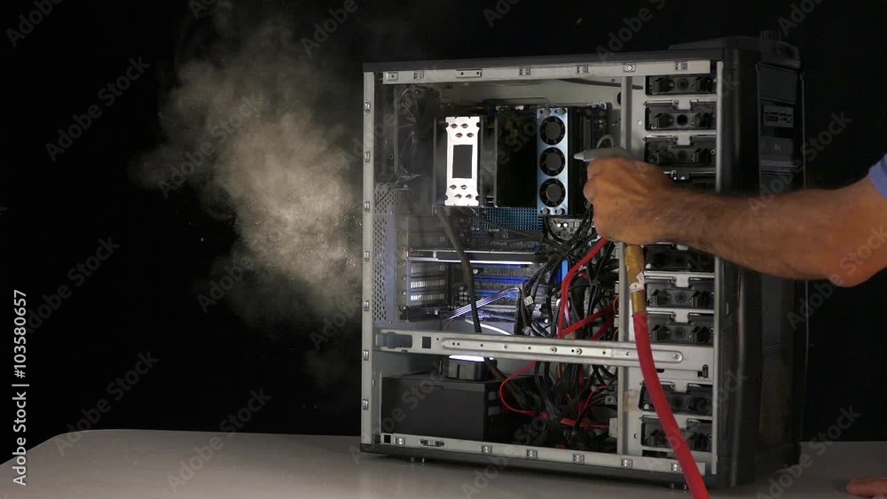 Computer maintenance with air gun blower. Dust blowing from computer ...