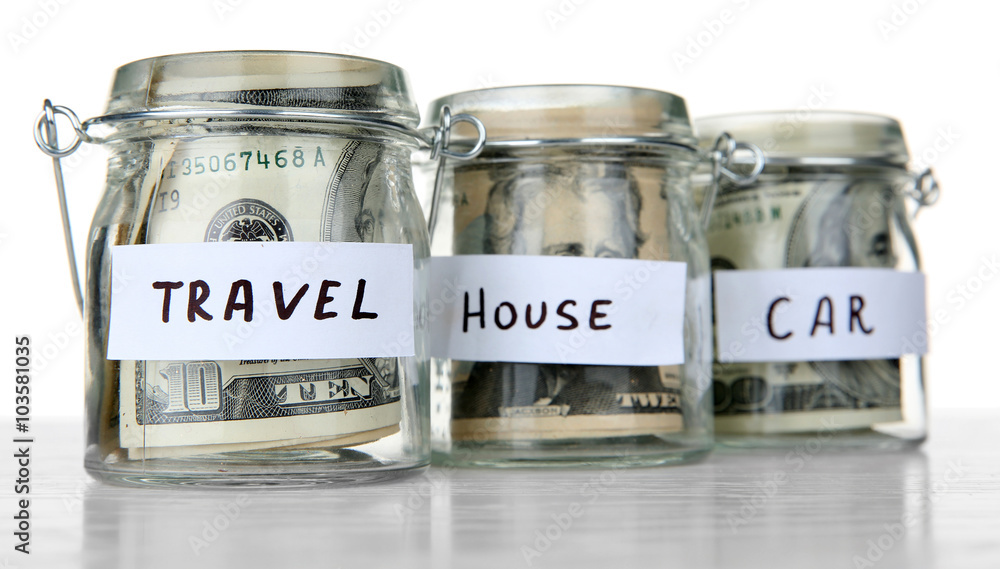 Three jars for different needs full of coins Stock Photo | Adobe Stock