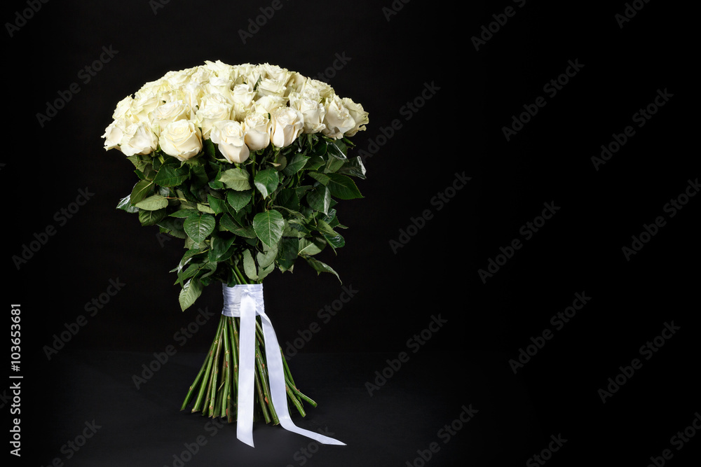 Romantic bouquet of lush 51 white roses on a black studio background ...