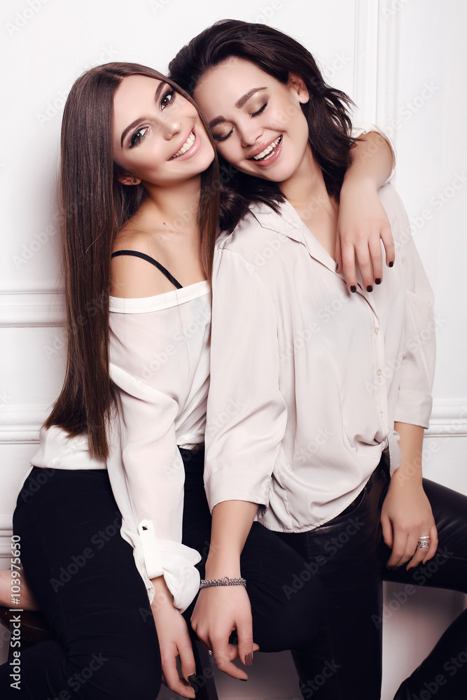 fashion studio photo of two beautiful young women with dark hair ...