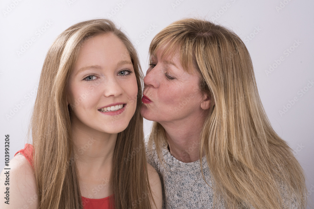 Portrait of a mother kissing her teenage daughter Stock Photo | Adobe Stock Portrait of a mother kissing her teenage daughter Stock Photo | Adobe Stock