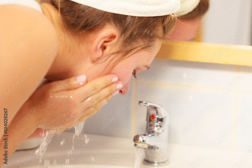 Woman washing face in bathroom. Hygiene Stock Photo | Adobe Stock