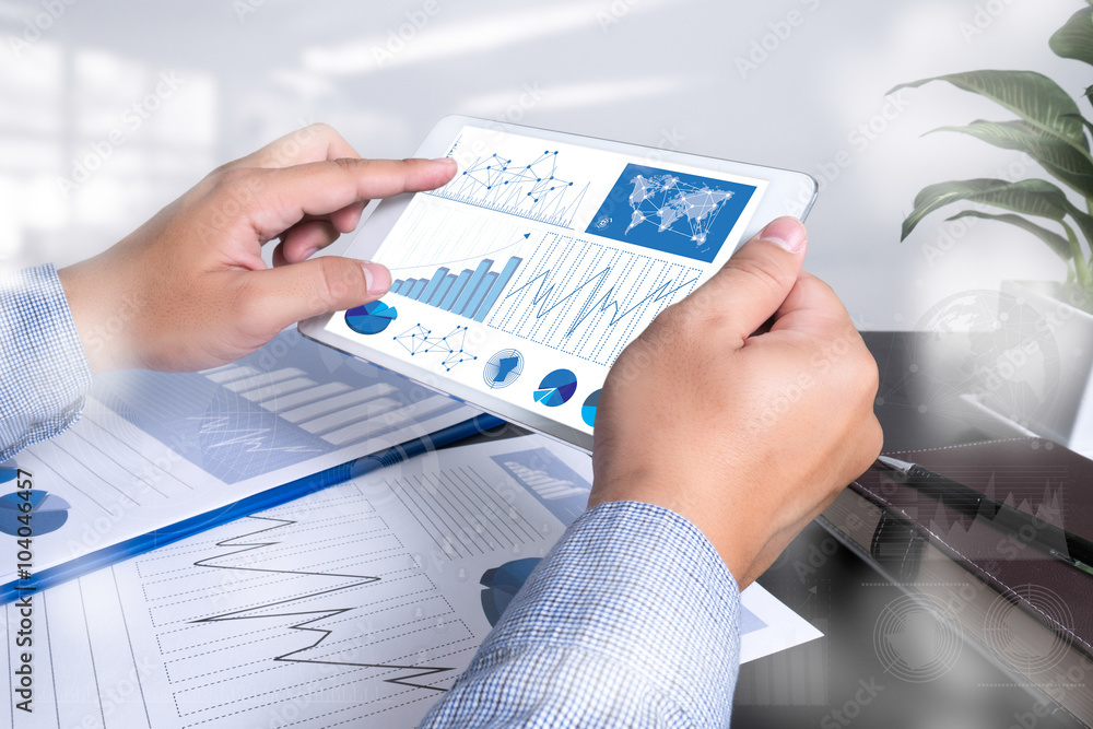 documents on office table with laptop computer and digital graph Stock ...