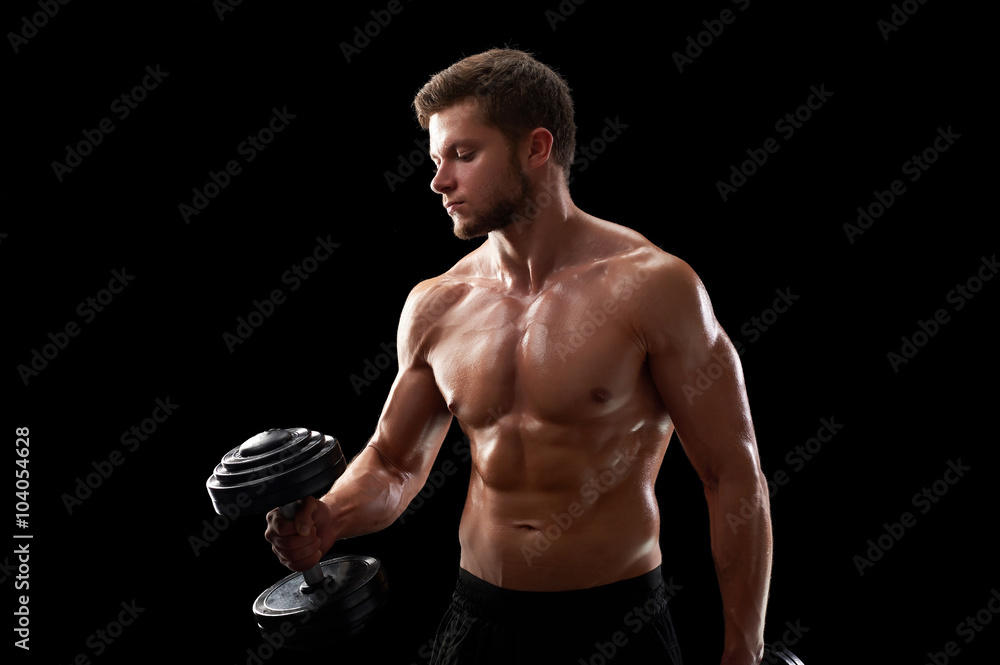 In finest form. Handsome ripped guy exercising with a dumbbell on black ...