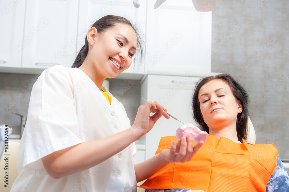 Dentist show dentures to a patient Stock Photo | Adobe Stock