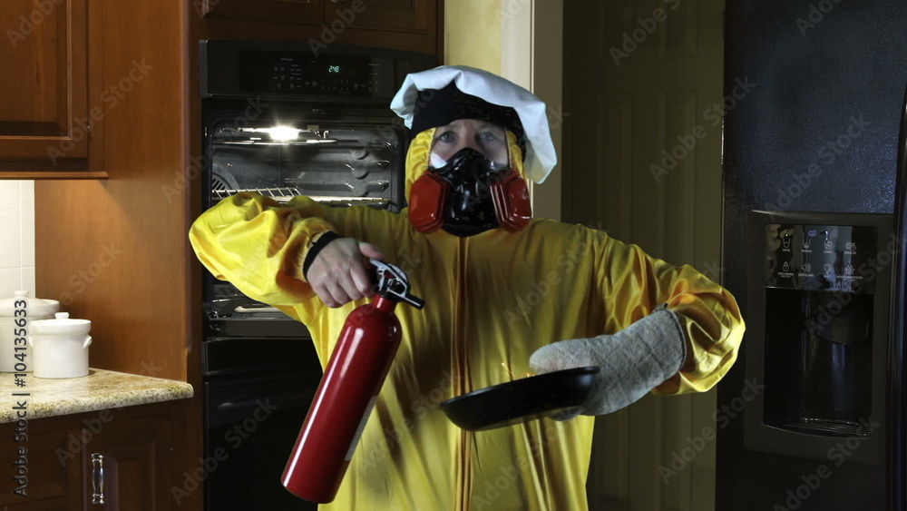 Woman wearing HazMat suit with Chefs Hat holding fire extinguisher and ...