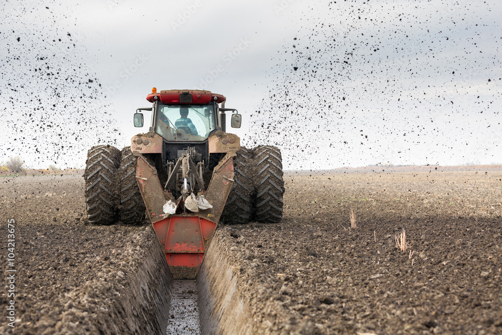 Tractor with double wheeled ditcher digging drainage canal Stock Photo ...