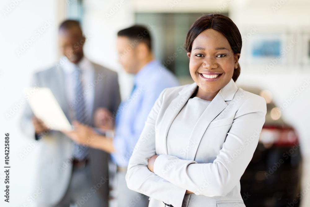 young african saleswoman inside vehicle showroom Stock Photo | Adobe Stock