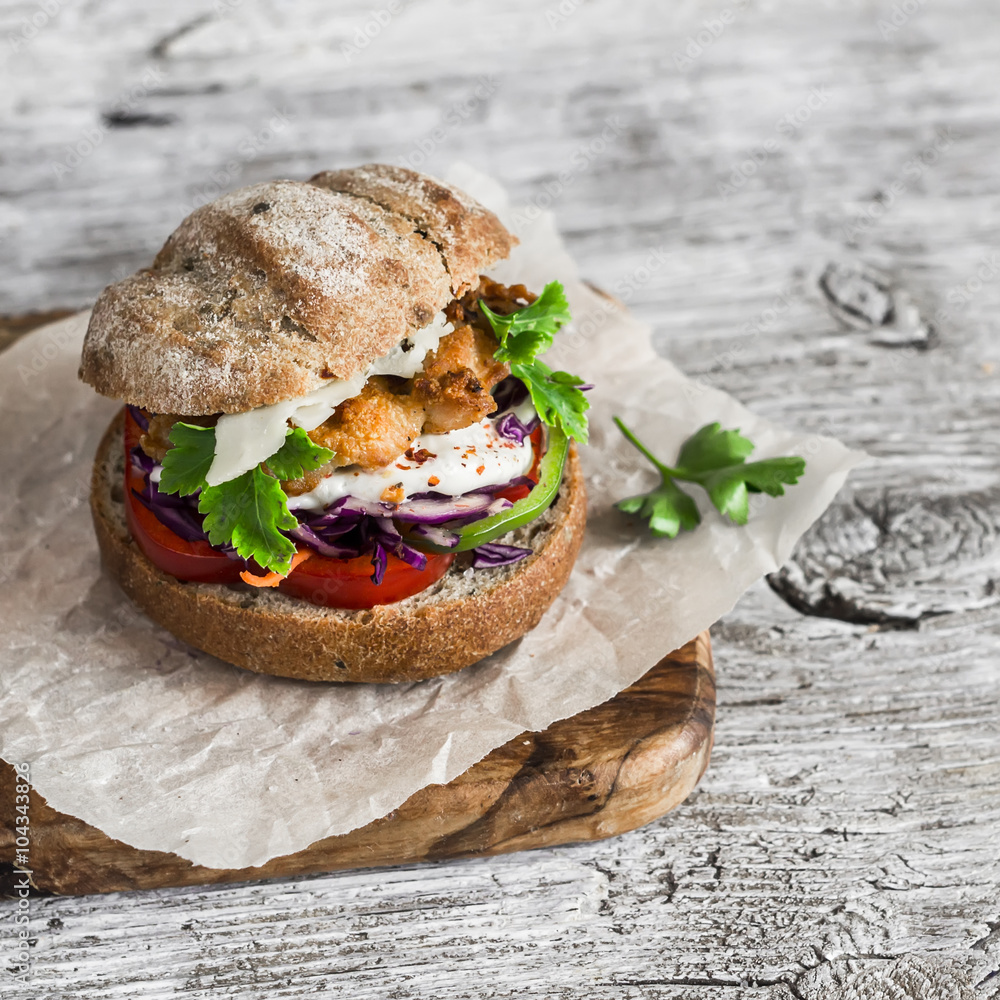 Homemade crispy fish burger on a light rustic wooden board Stock Photo ...