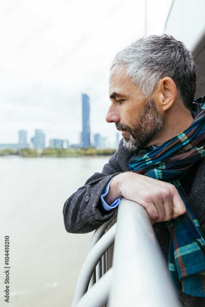 Austria, Vienna, man leaning on railing of Reichsbruecke looking at ...