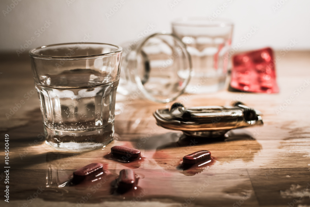 Mini car crash. Vodka shot, meting pills and overturned toy car on a ...