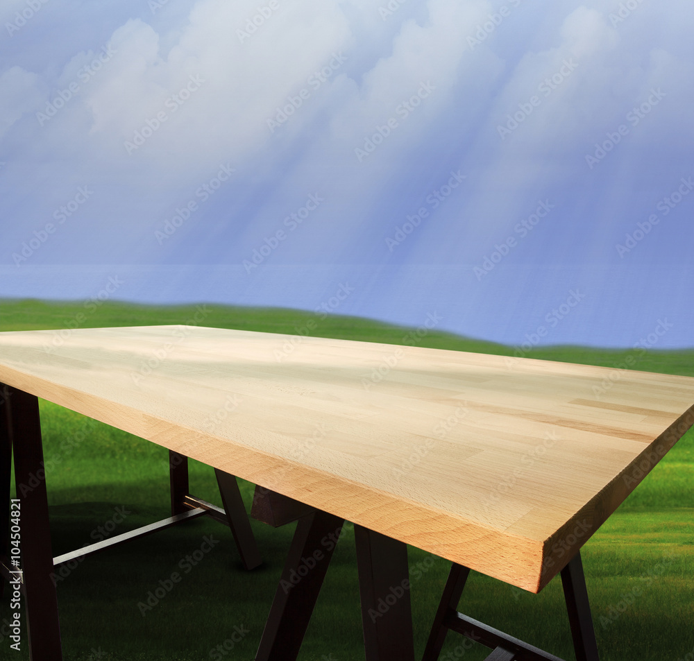top of empty wood table with natural green grass field and blue Stock ...
