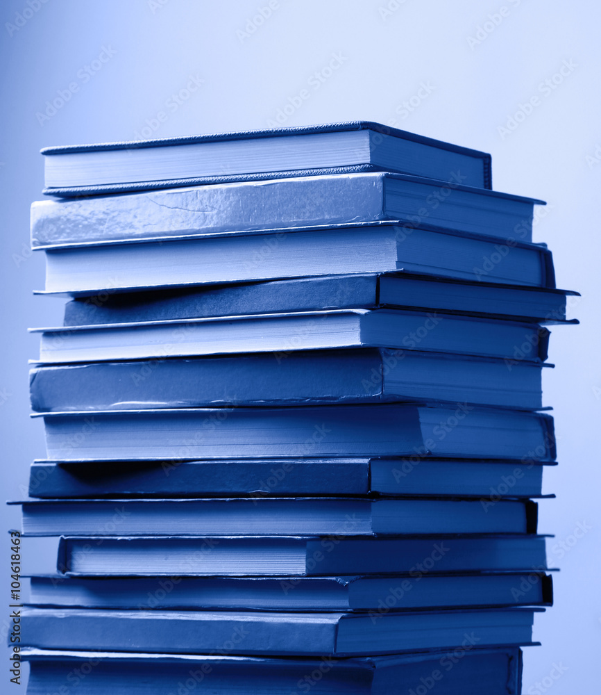 Stack of blue books on light blue background Stock Photo | Adobe Stock