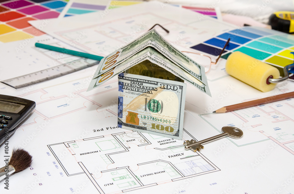 dollar banknotes as model house on a construction plan for house ...
