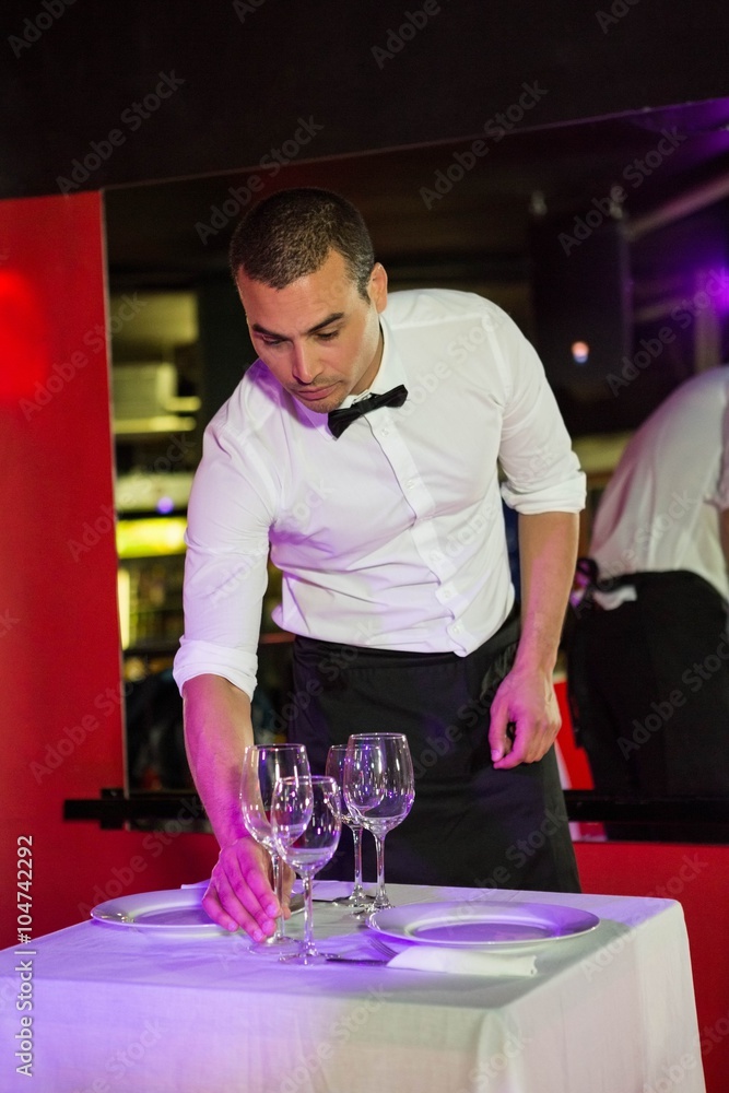 Waiter setting a table Stock Photo | Adobe Stock