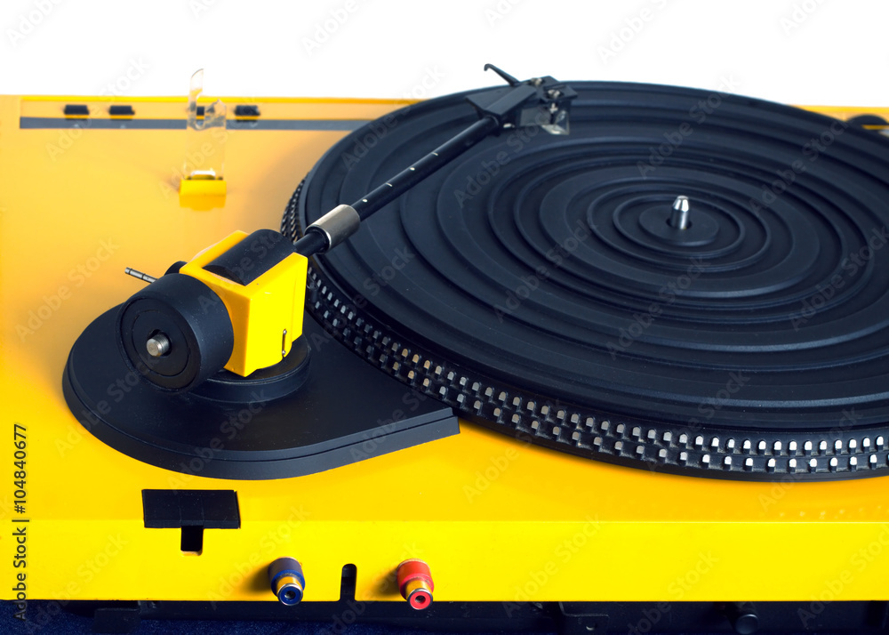 Turntable with black tonearm in yellow case with rubber mat on disc ...